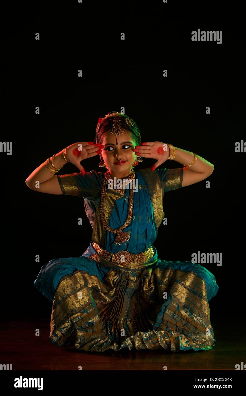 Young bharatnatyam dancer doing a ardha chandra mudra during a ...