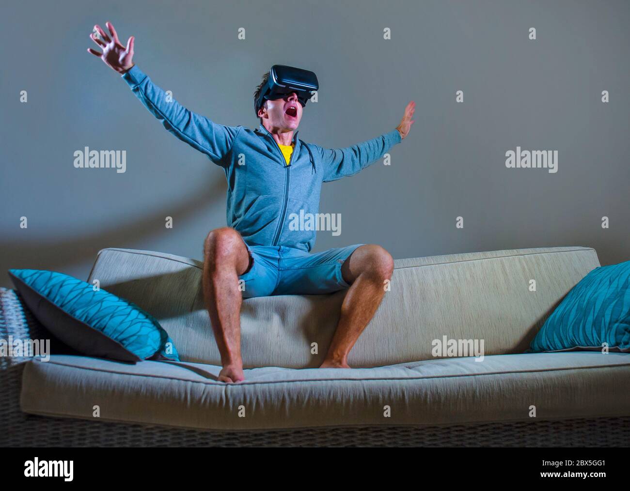 young attractive gamer man using VR goggles headgear technology playing ...