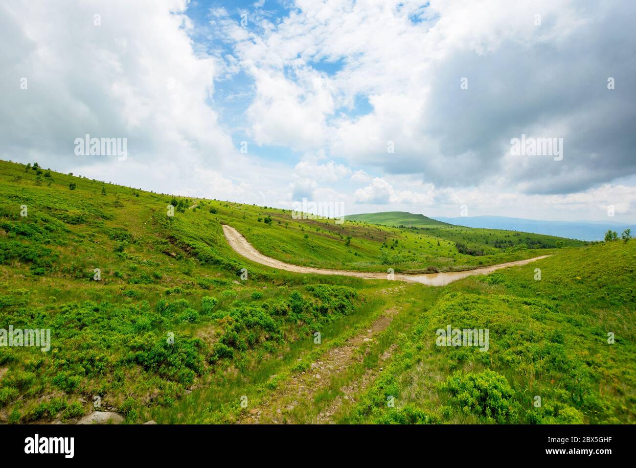 path through mountain landscape. road through green rolling hills ...