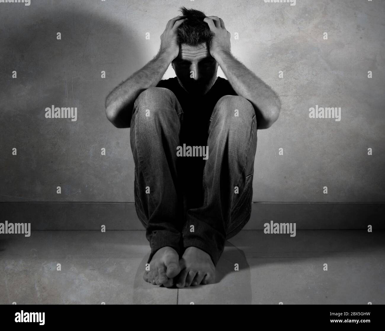 black and white portrait of desperate man crying sad sitting at home ...