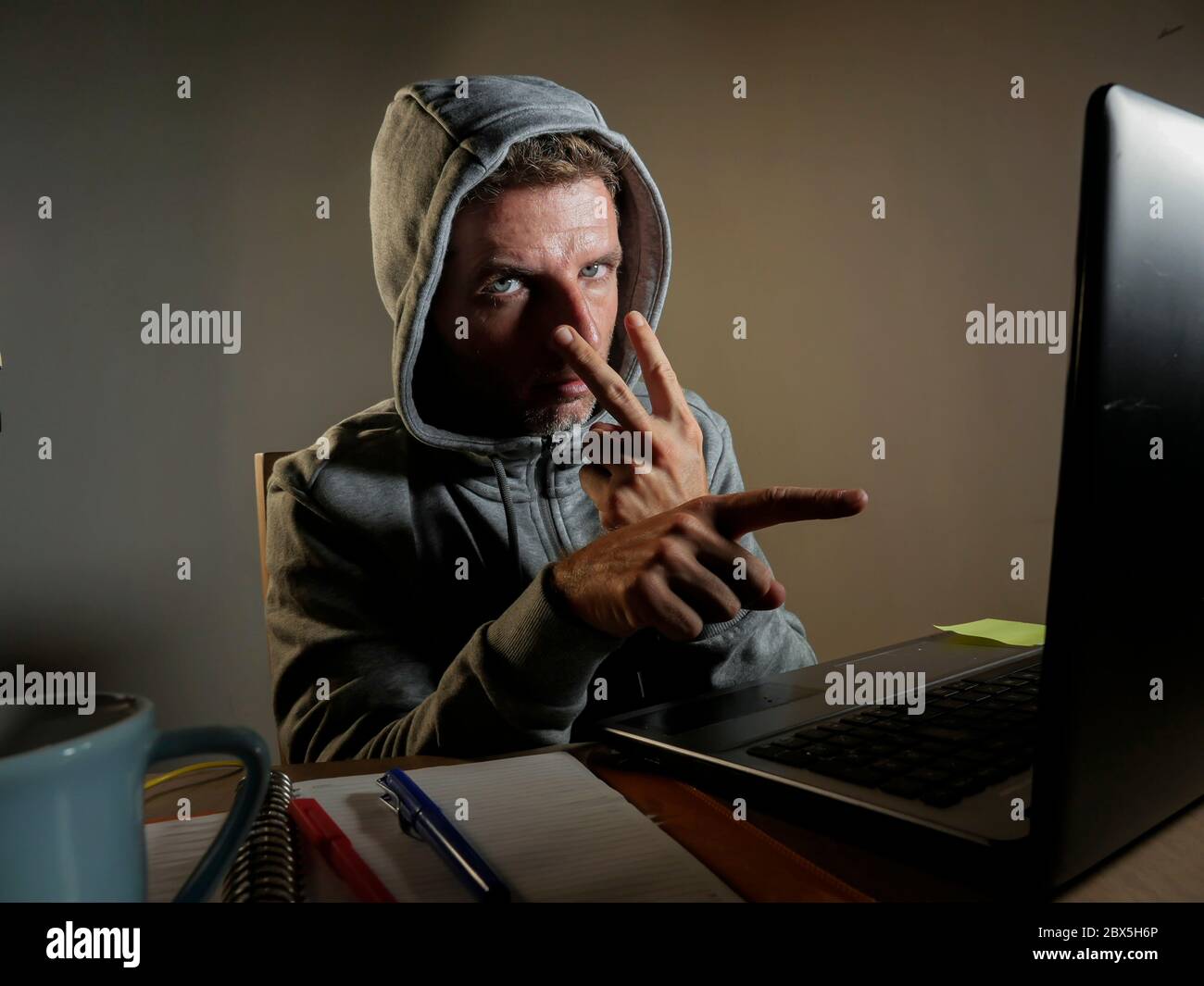 Dangerous Looking Hacker Man In Hoodie Hacking Internet Computer System