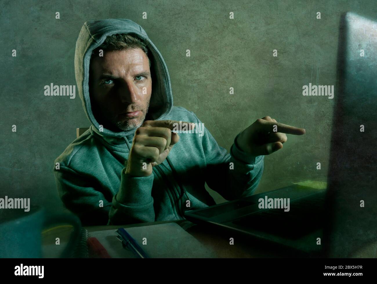 Dangerous Looking Hacker Man In Hoodie Hacking Internet Computer System