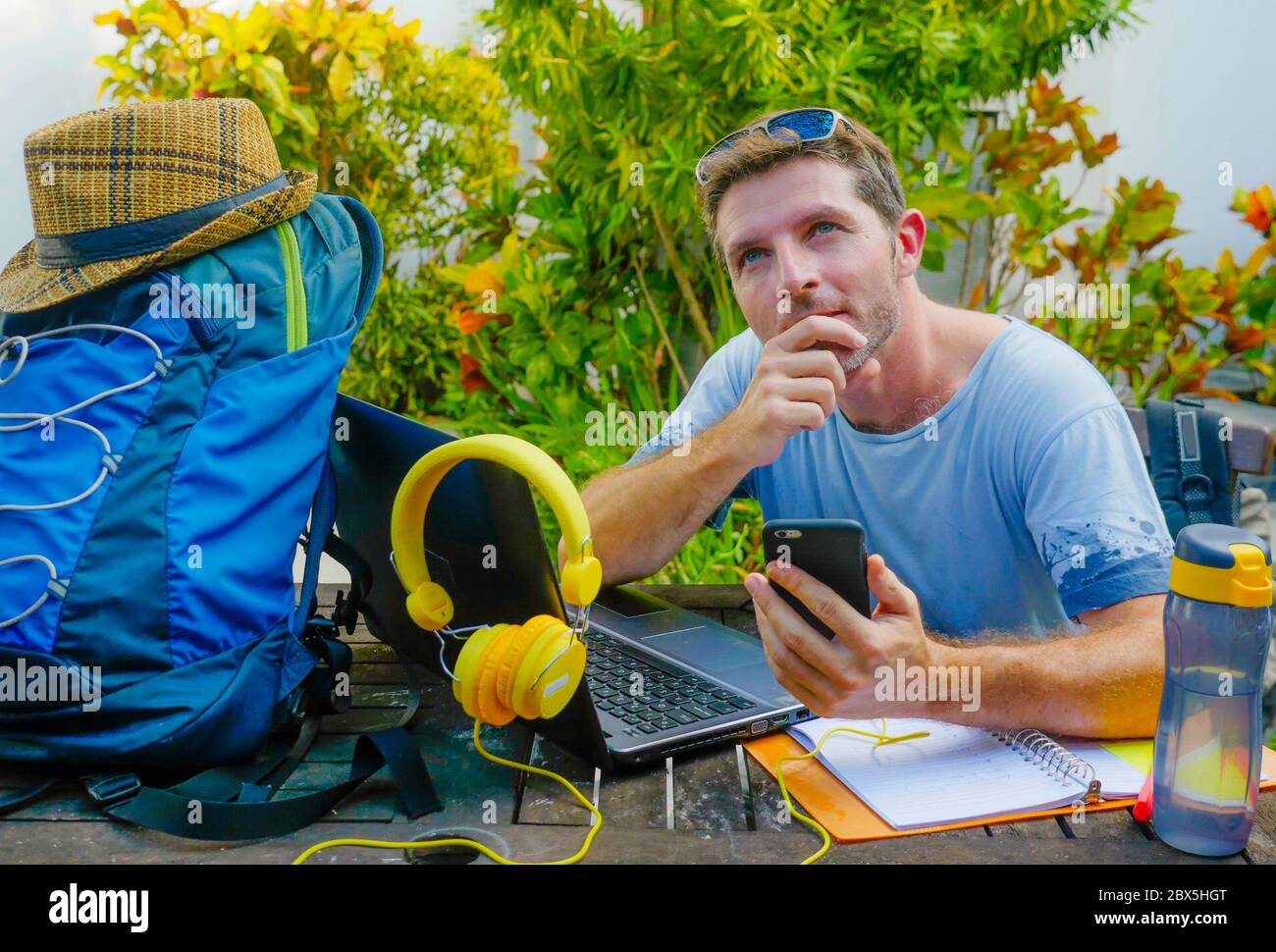 young attractive and happy digital nomad man working outdoors with ...