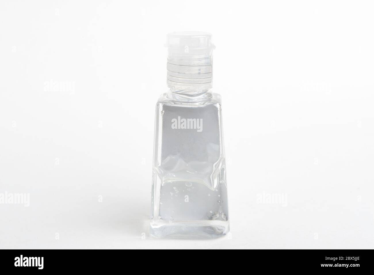 A product shot of a generic pocket-size transparent hand sanitizer ...