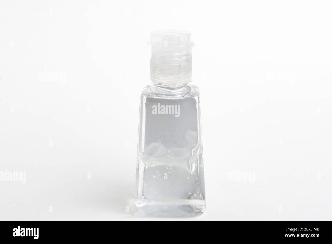 A product shot of a generic pocket-size transparent hand sanitizer ...