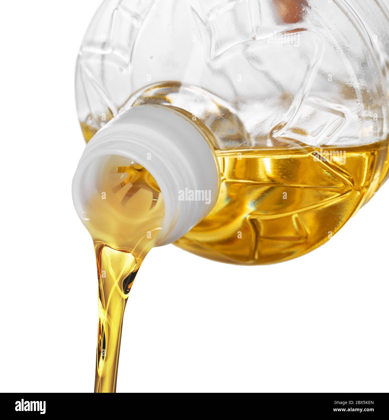 Pouring oil for cooking in a bottle isolated on white background Stock ...