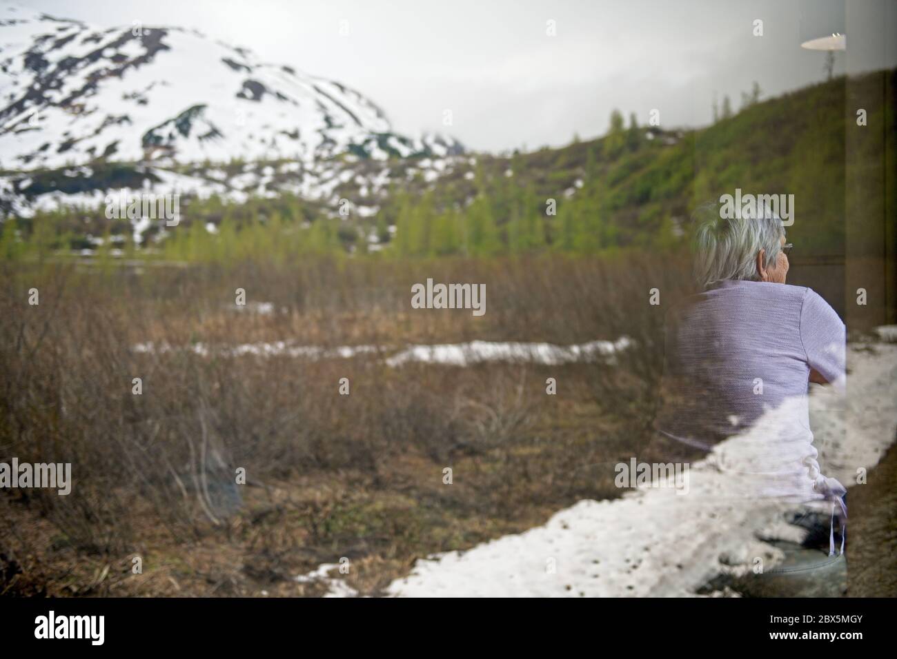 Woman Train Passenger Reflection from rear with Background of Mountains ...