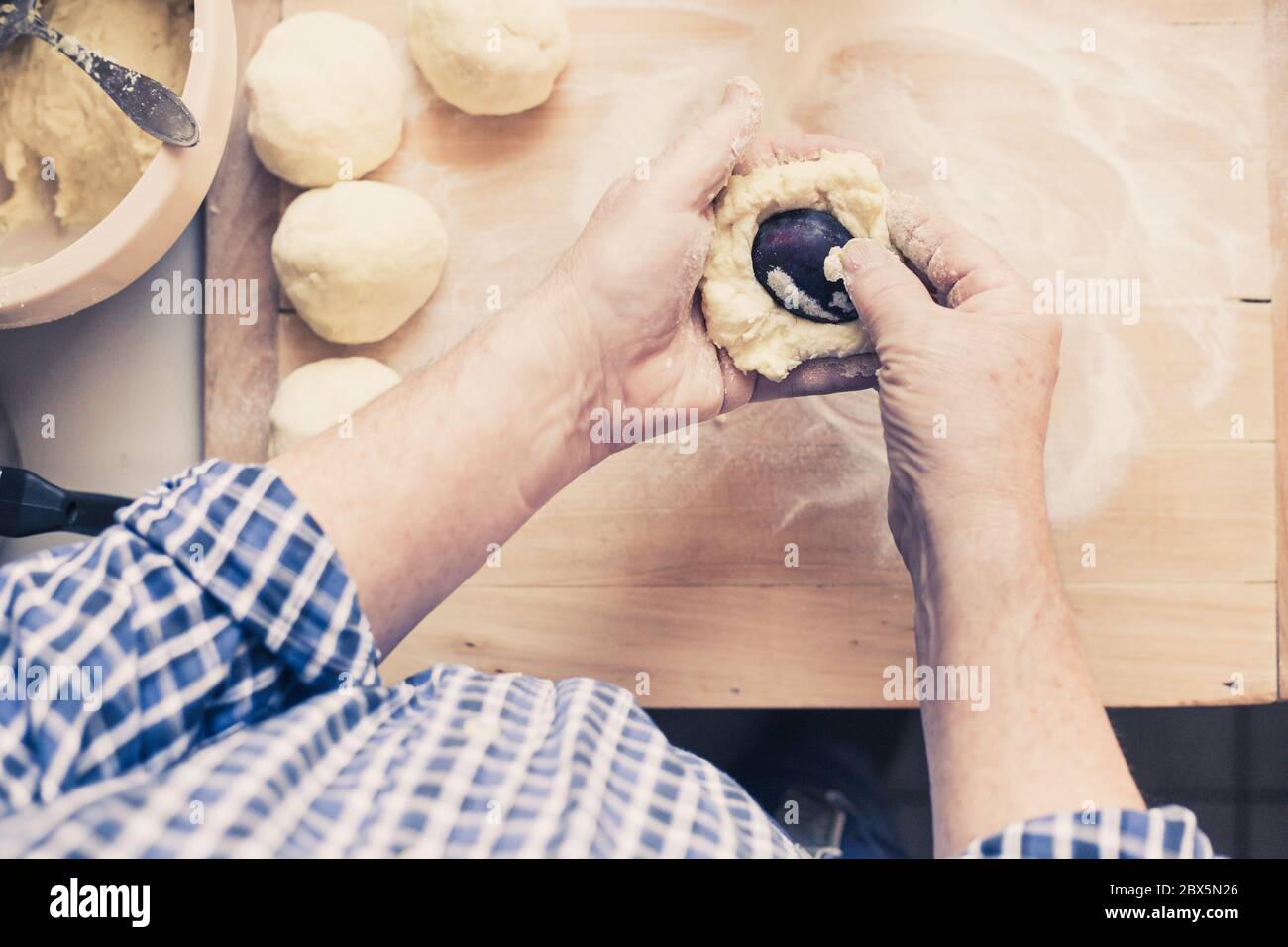Man hands making delicious plum dumplings from dough, food concept ...