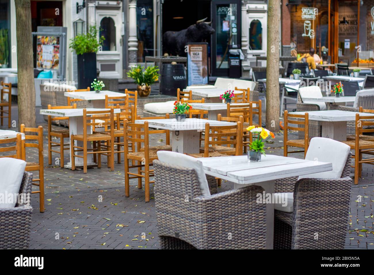 Outdoor restaurant terrace with enough of space between tables ...