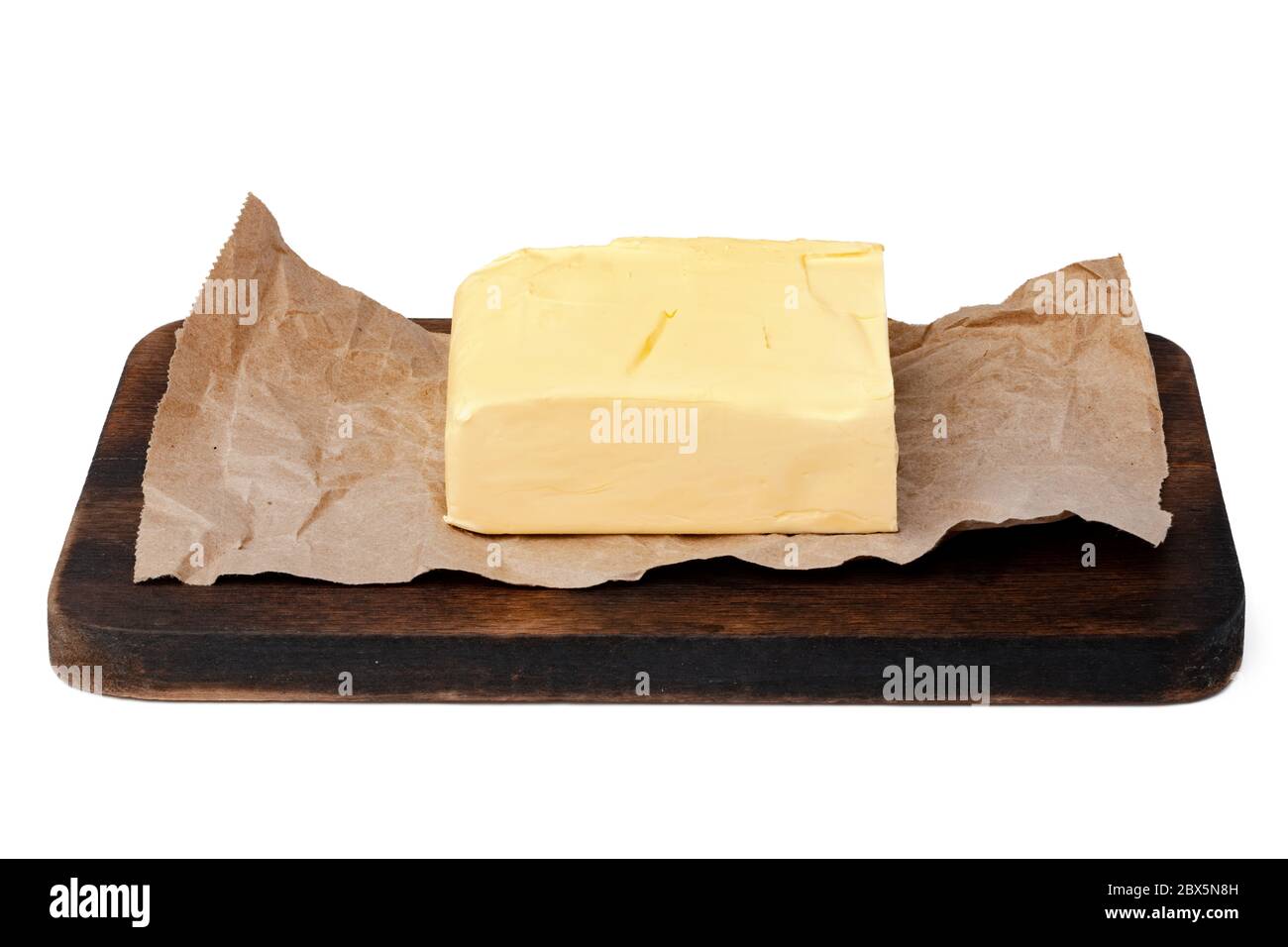 Butter on wooden board isolated on white background Stock Photo - Alamy