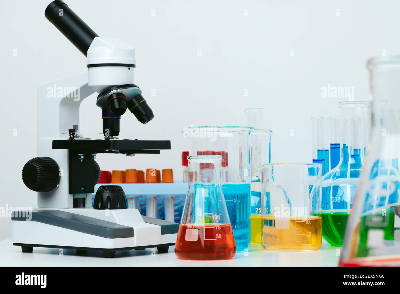 Scientific laboratory with microscope and test tubes with samples ...
