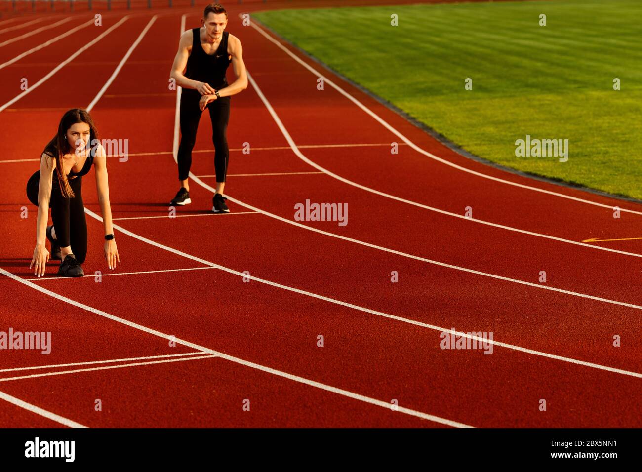 Beautiful sporty woman and young sporty man are ready to run on ...