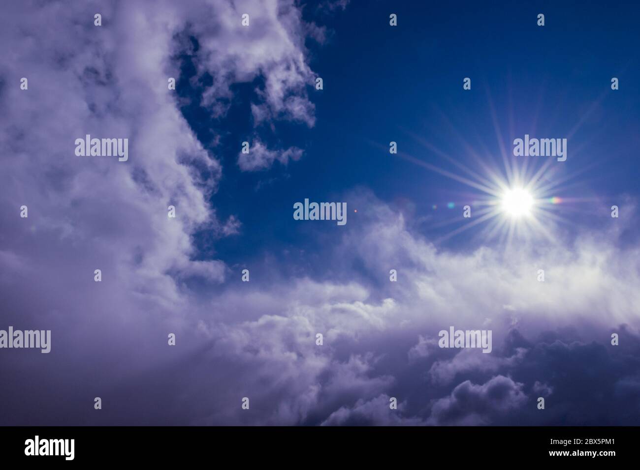 Sun shines through storm clouds hi-res stock photography and images - Alamy