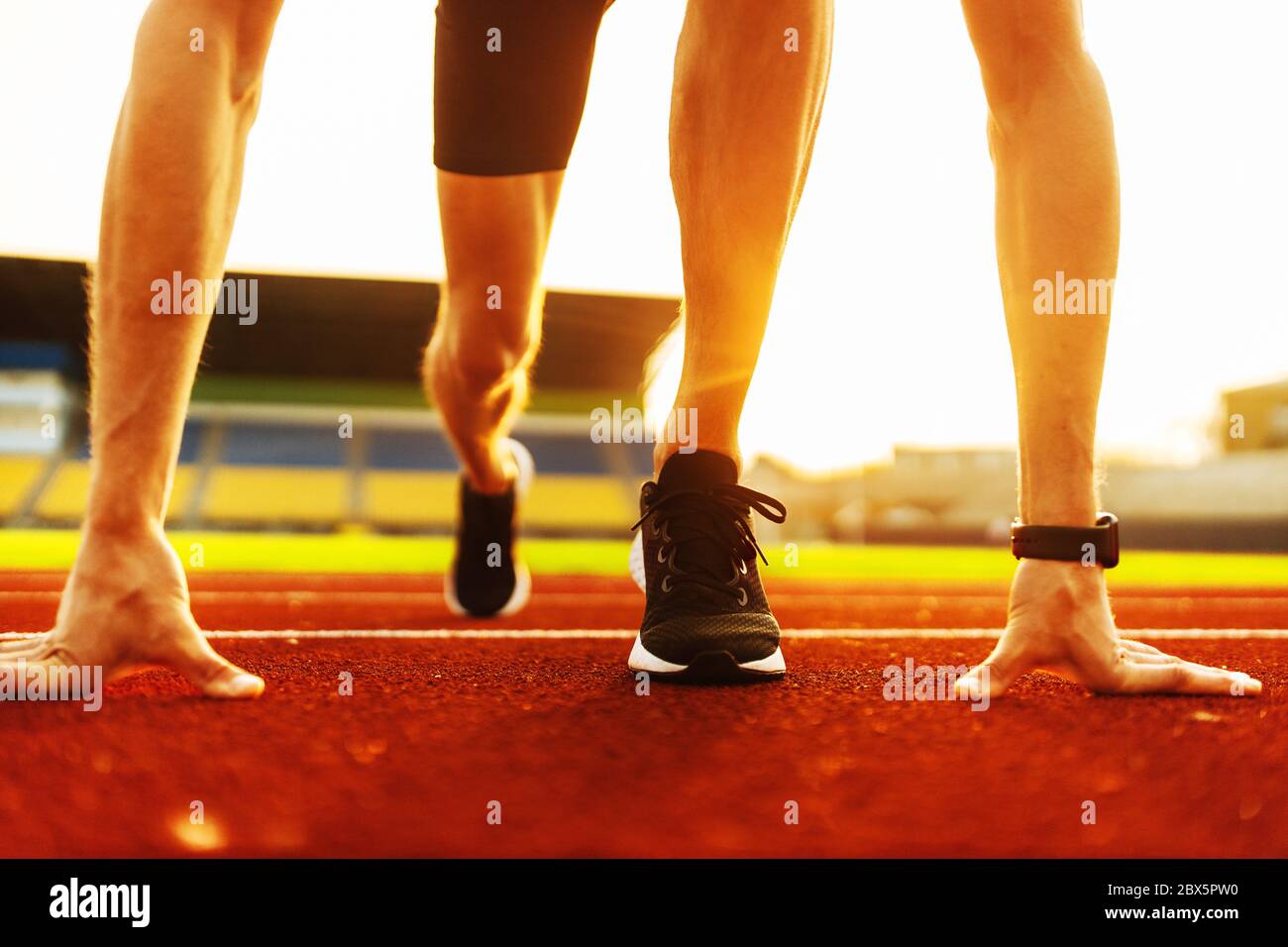Runner athlete feet running on road under sunlight Stock Photo - Alamy