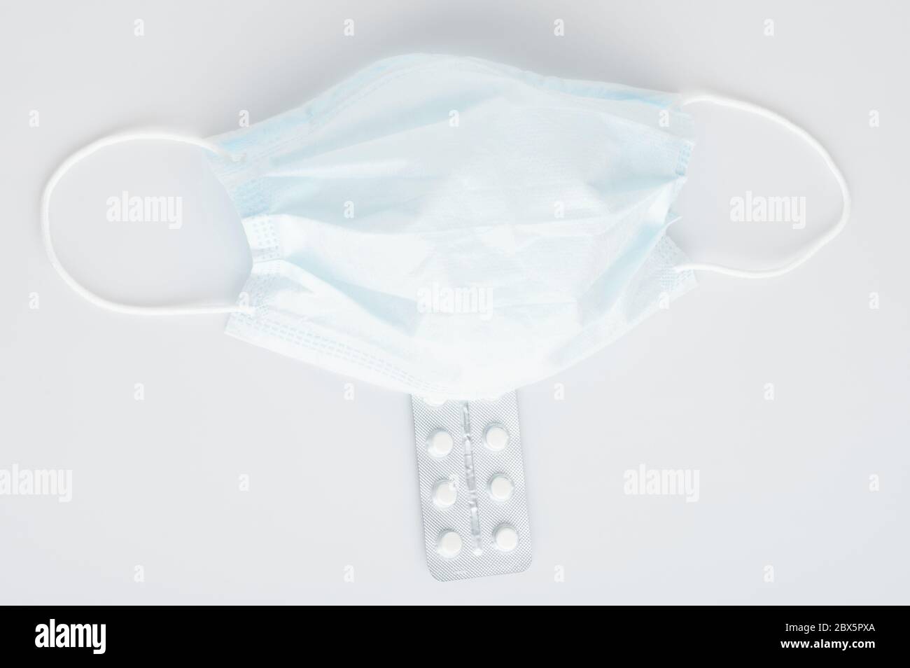 Face mask and pills isolated on white studio background Stock Photo - Alamy