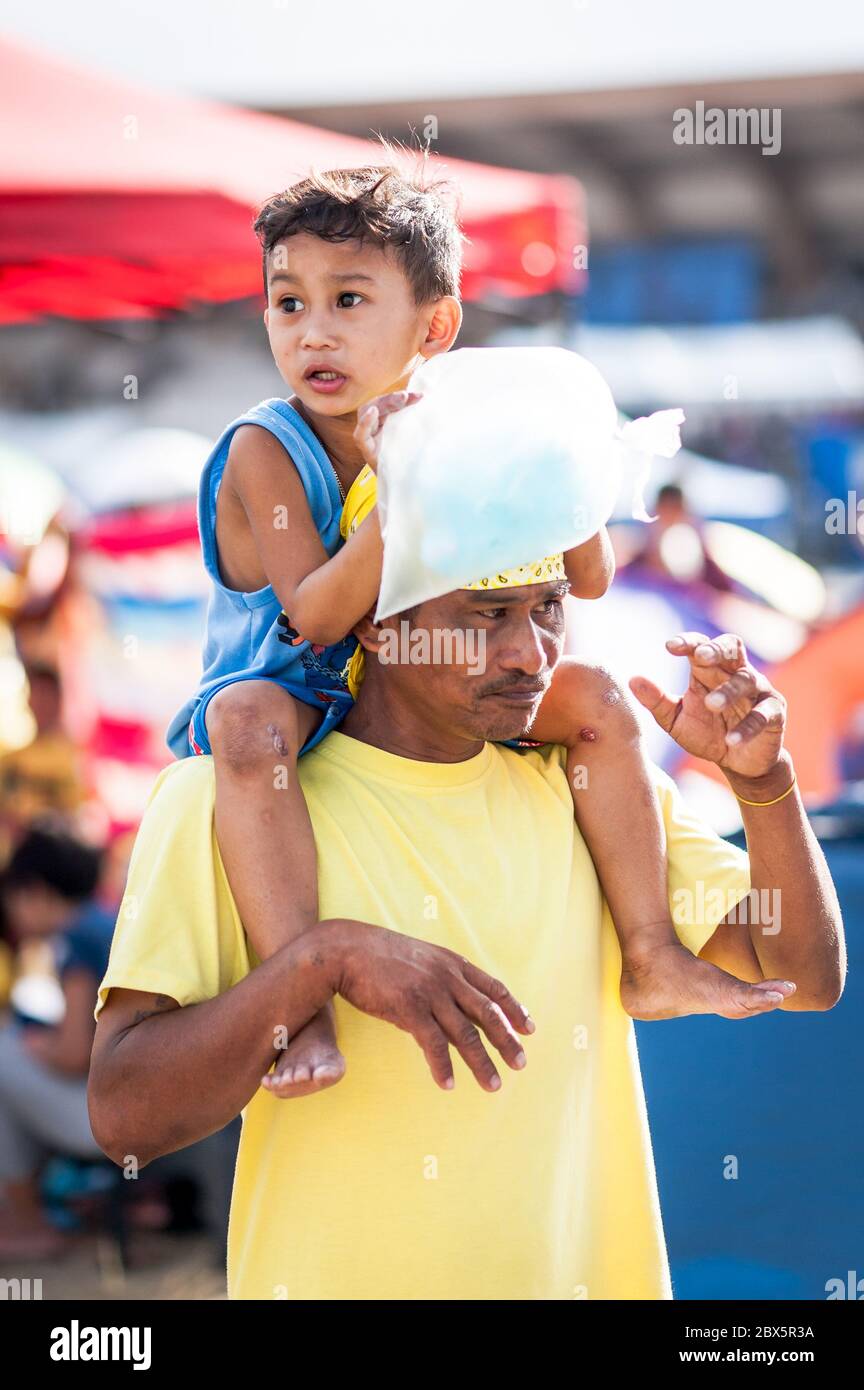 A filipino father enjoys a day out with his son as they watch the Feast ...