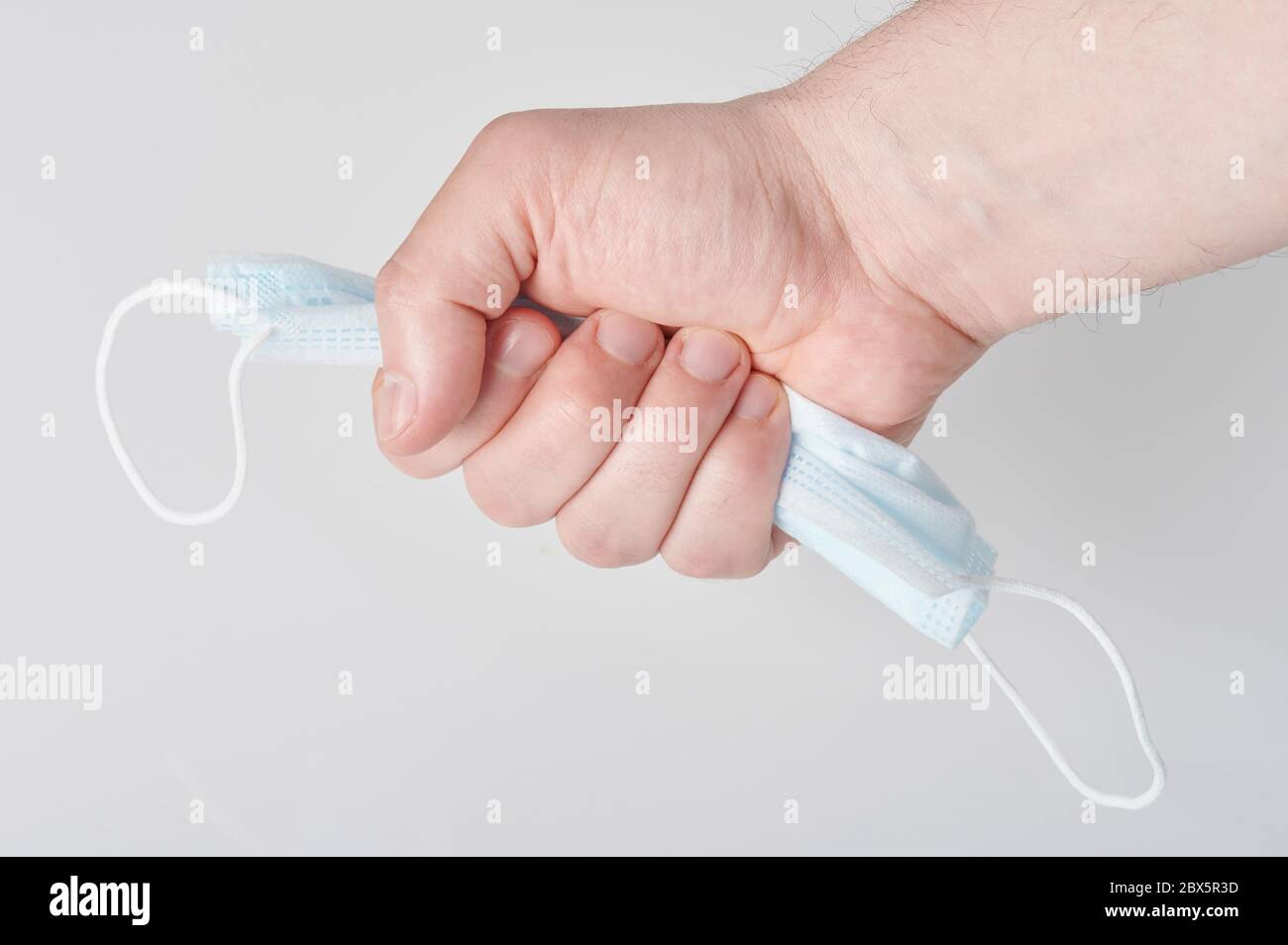 Hand squeeze face mask close up view isolated Stock Photo - Alamy