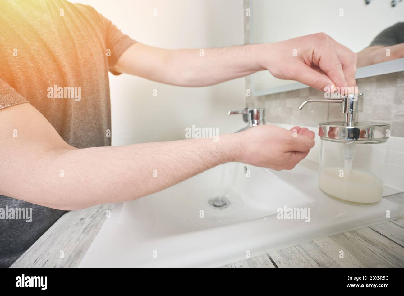 Pouring soap in hands macro close up view in sink Stock Photo - Alamy