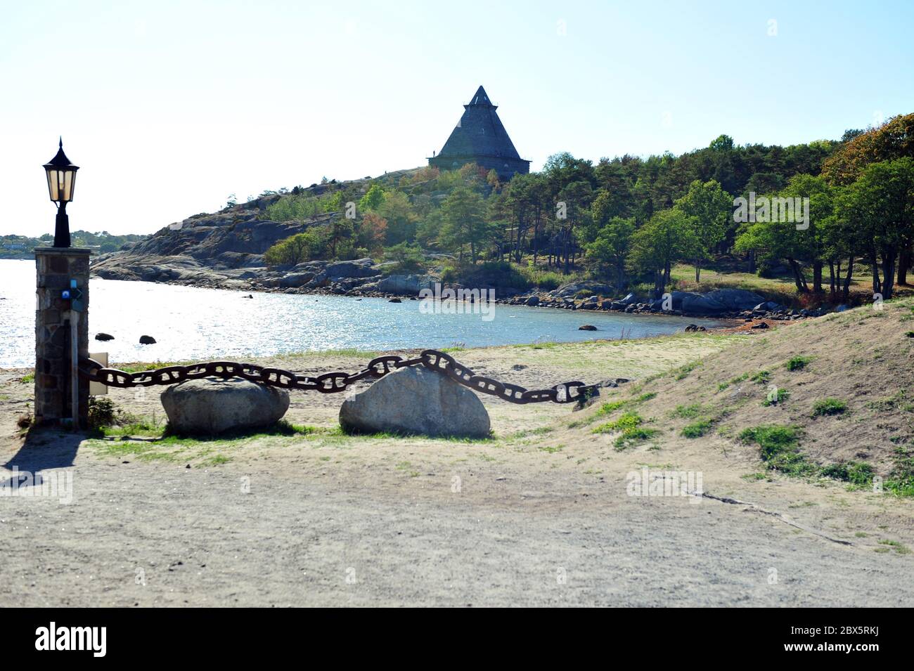 Memorial pyramid in Stavern, Vestfold, Norway. Sand beach and boulders ...