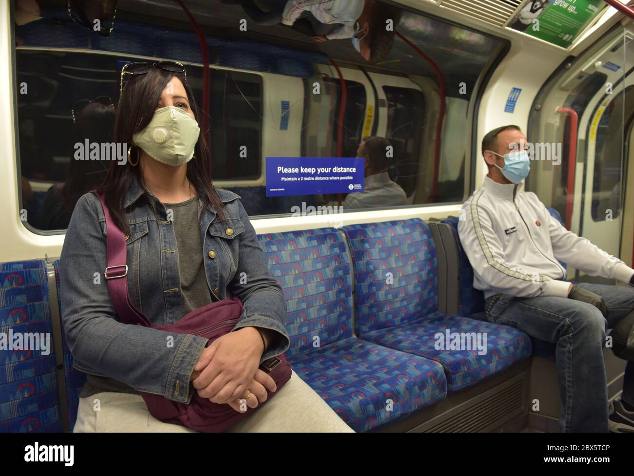 Passengers wear face masks on a Central Line underground train ...