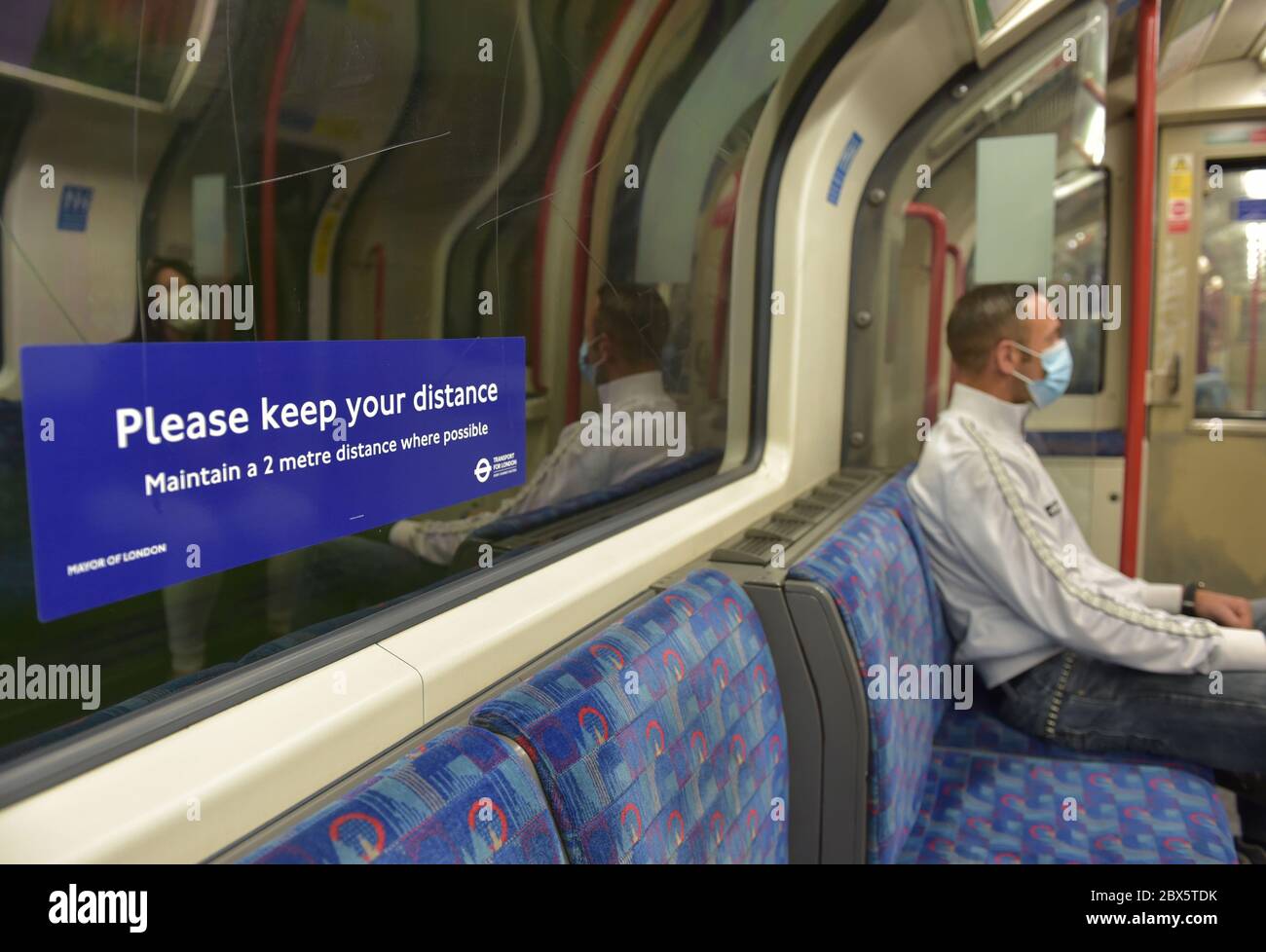 A passengers wear a face mask on a Central Line underground train ...