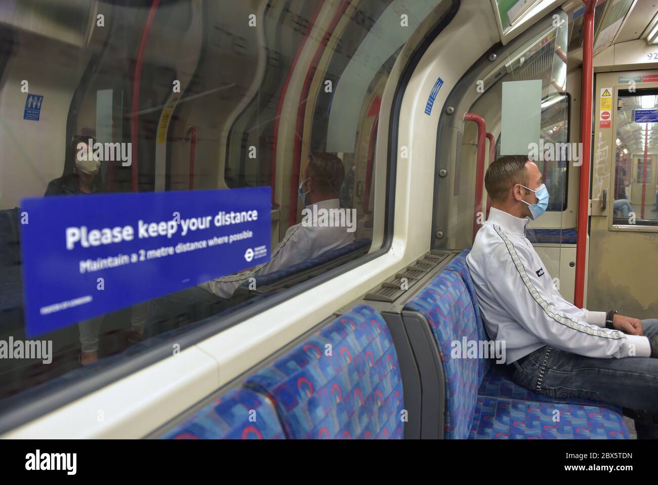 Passengers wear face masks on a Central Line underground train ...