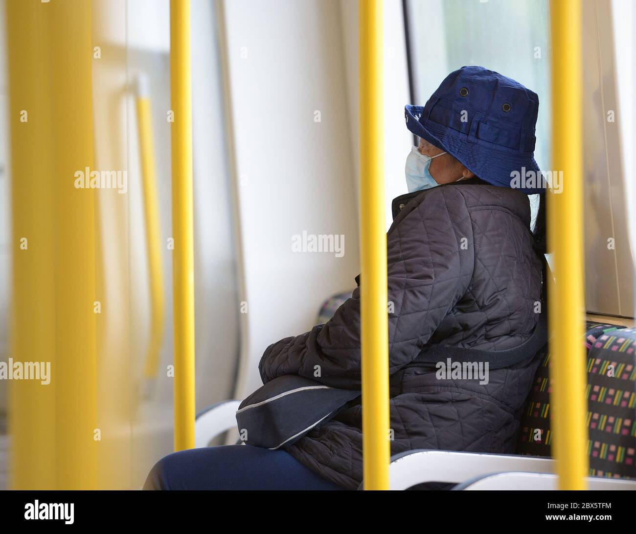 A passenger wears a face mask on a District Line underground train ...