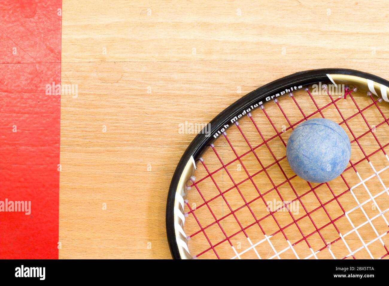 Close up of a squash racket and ball on the wooden background, sport ...
