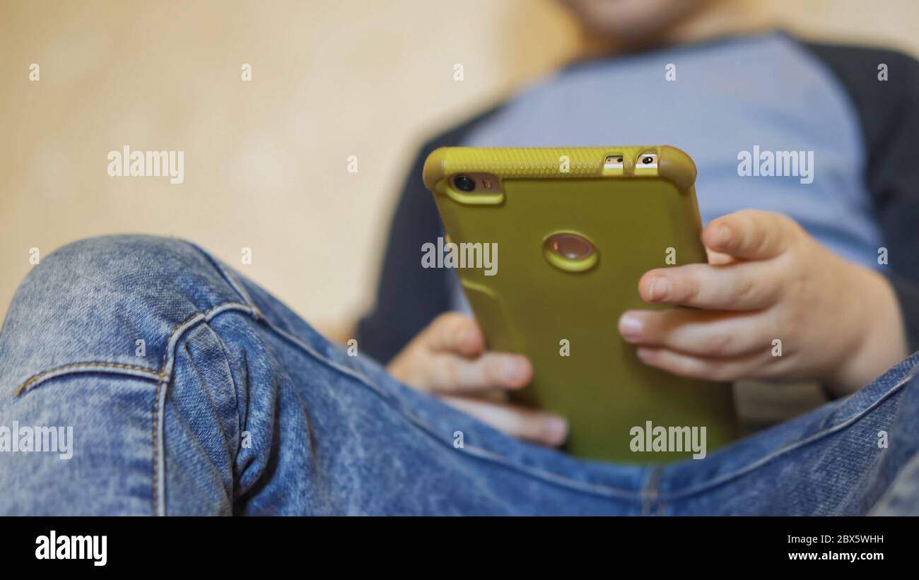 Boy uses mobile phone staying at home.. Preschooler child using ...