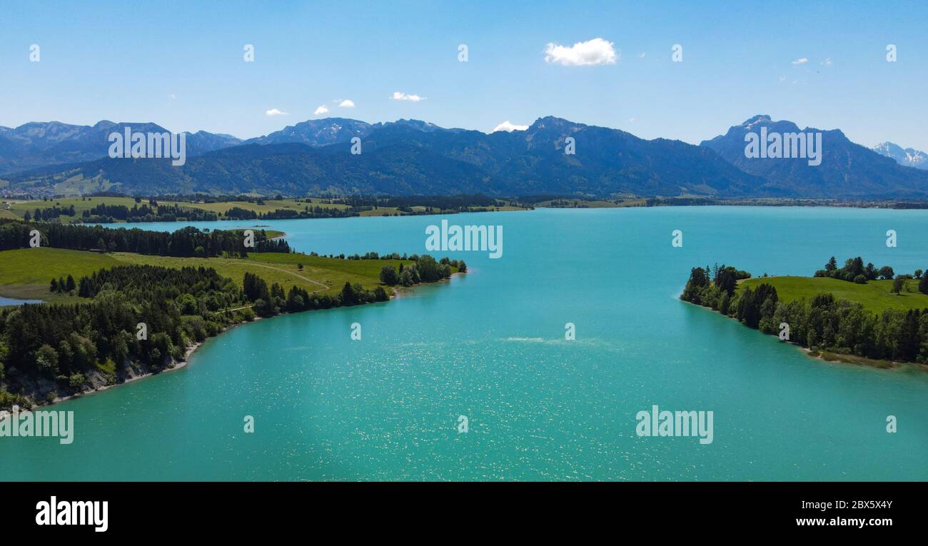 Aerial view over Lake Forggensee at the city of Fuessen in Germany ...