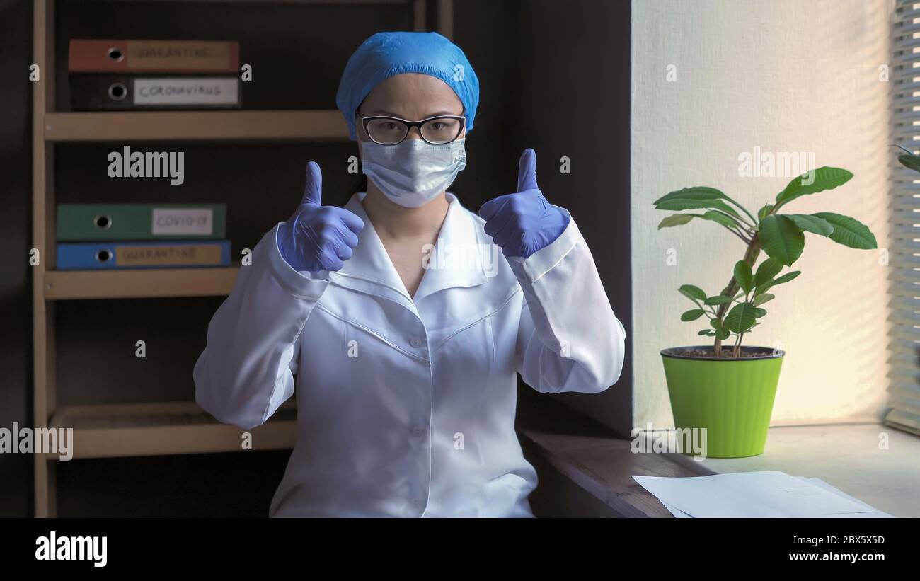 Positive doctor shows encouraging Yes gesture. Thumbs up gesture from ...