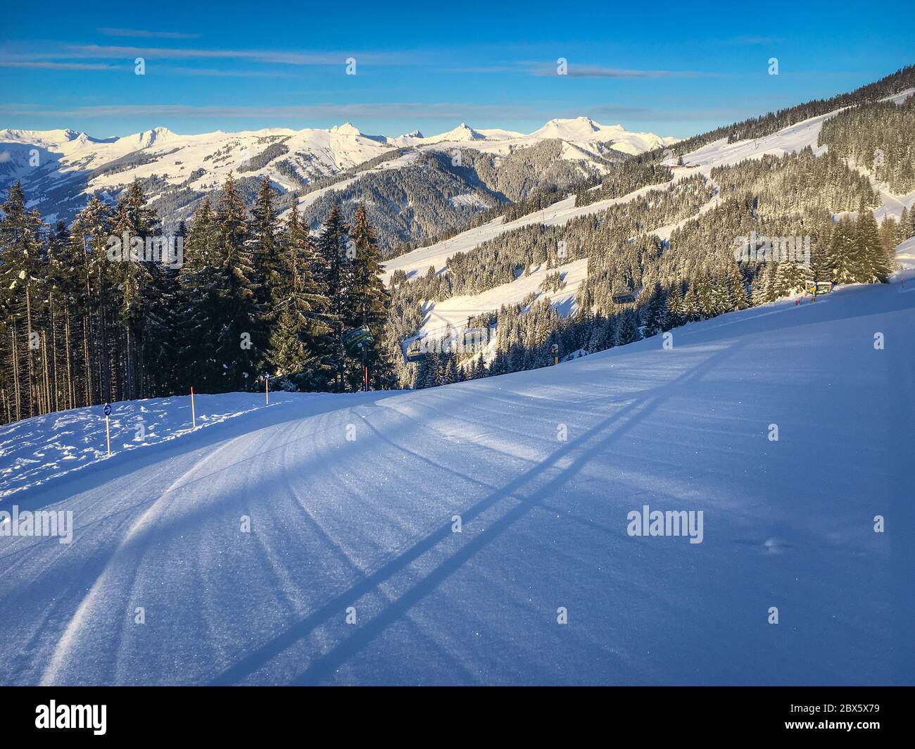 Untouched ski slope with fresh snow and scenic view of Saalbach ...