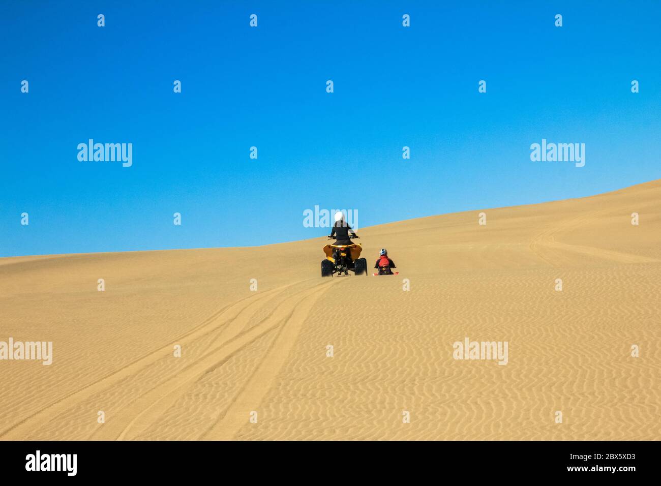 Quad driving people - two happy bikers in sand desert dunes, Africa ...