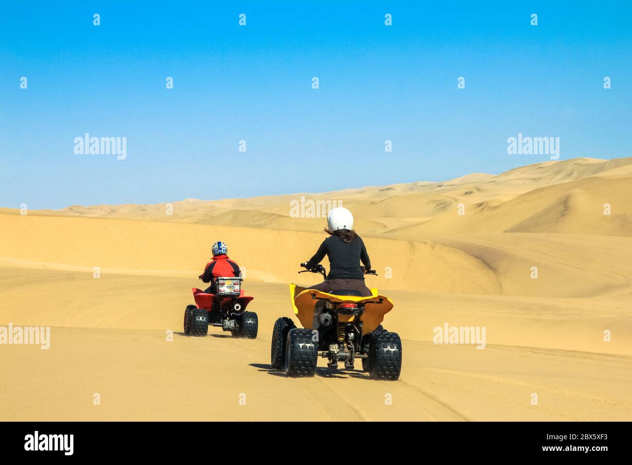 Quad driving people - two happy bikers in sand desert dunes, Africa ...