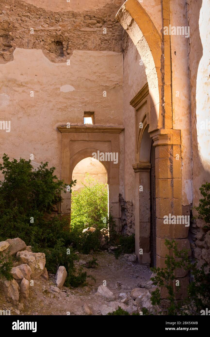 Abandoned old ruined building. Gate with an arc without door. Ruined ...