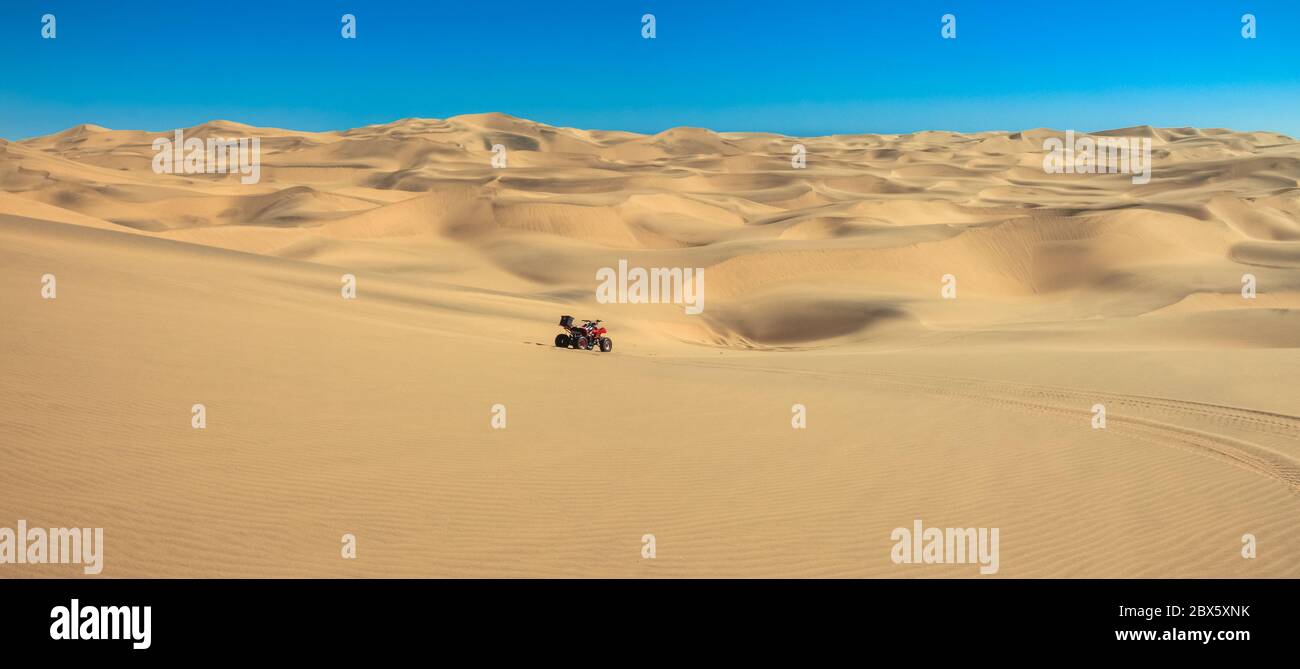 Quad driving in sand desert. ATV standing in middle of nowhere in sand ...