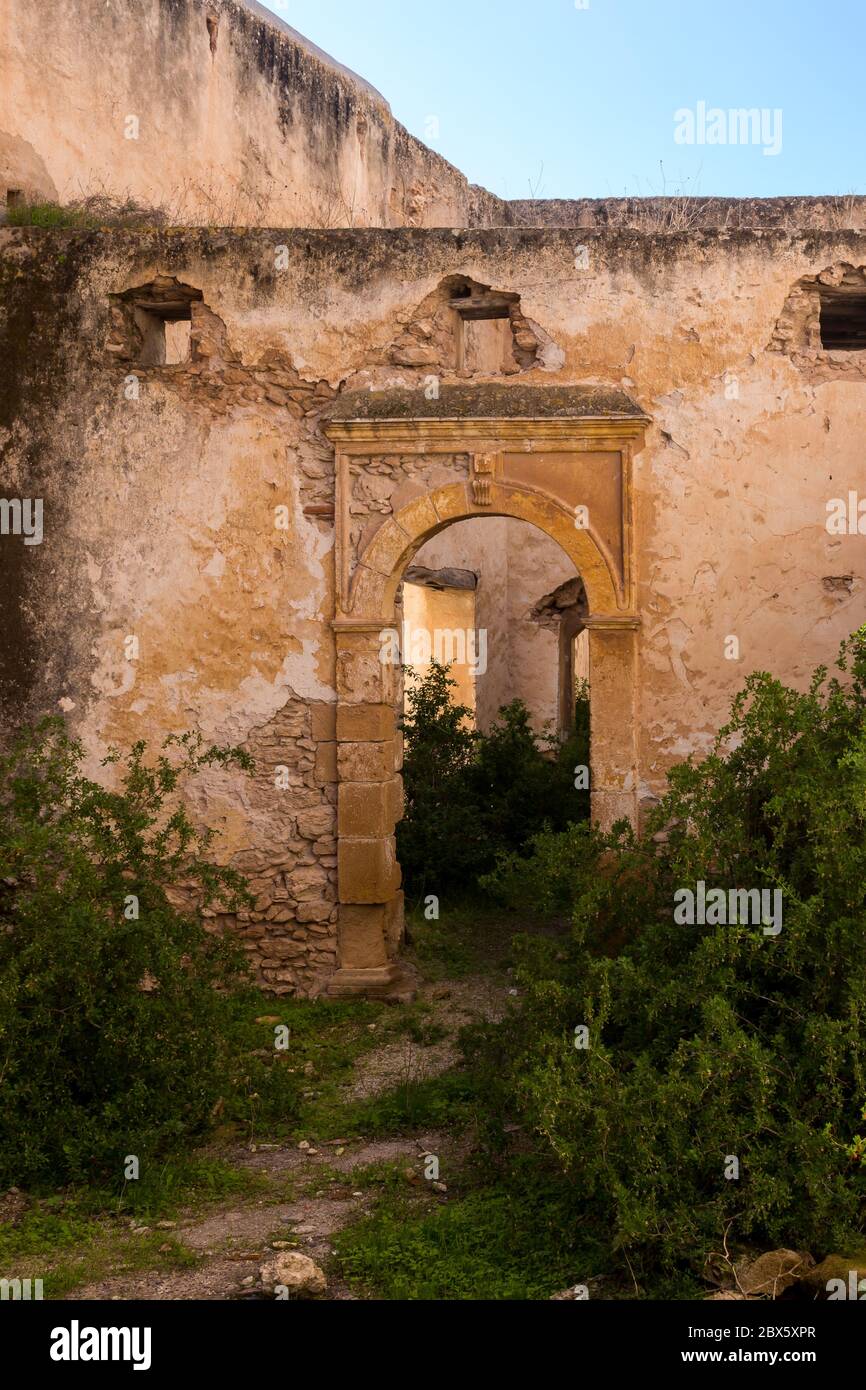 Abandoned old ruined building. Gate with an arc without door. Ruined ...