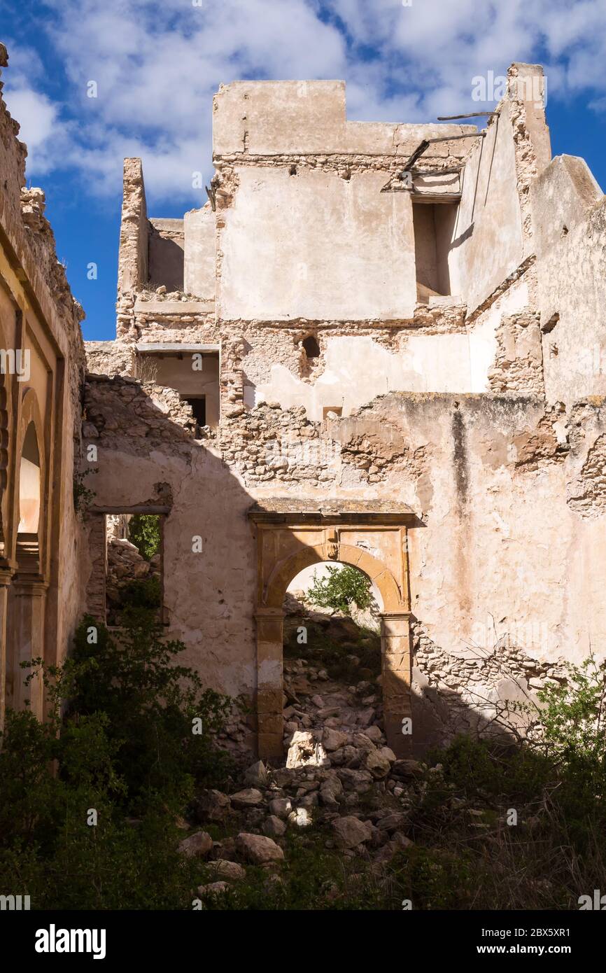 Abandoned old ruined building. Gate with an arc without door. Ruined ...