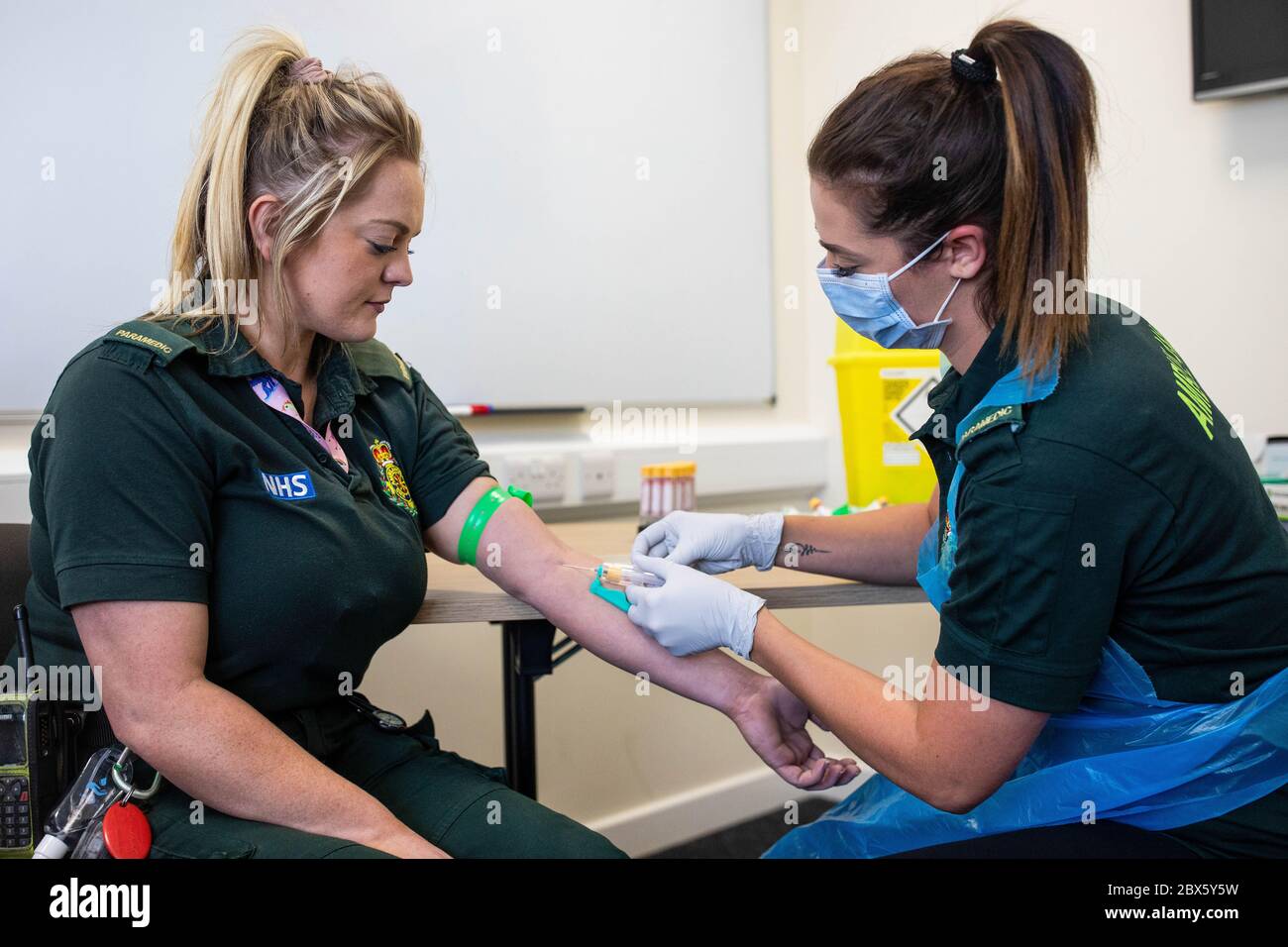 Paramedic jess baddams right takes blood sample from hi-res stock ...