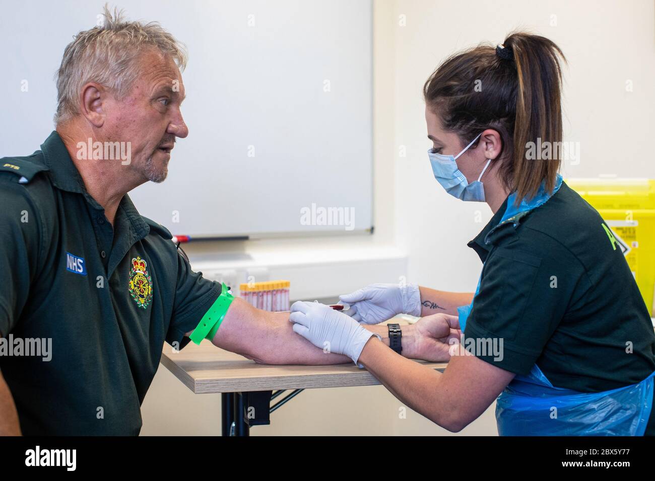 Paramedic jess baddams right takes blood sample from tony oliver hi-res ...