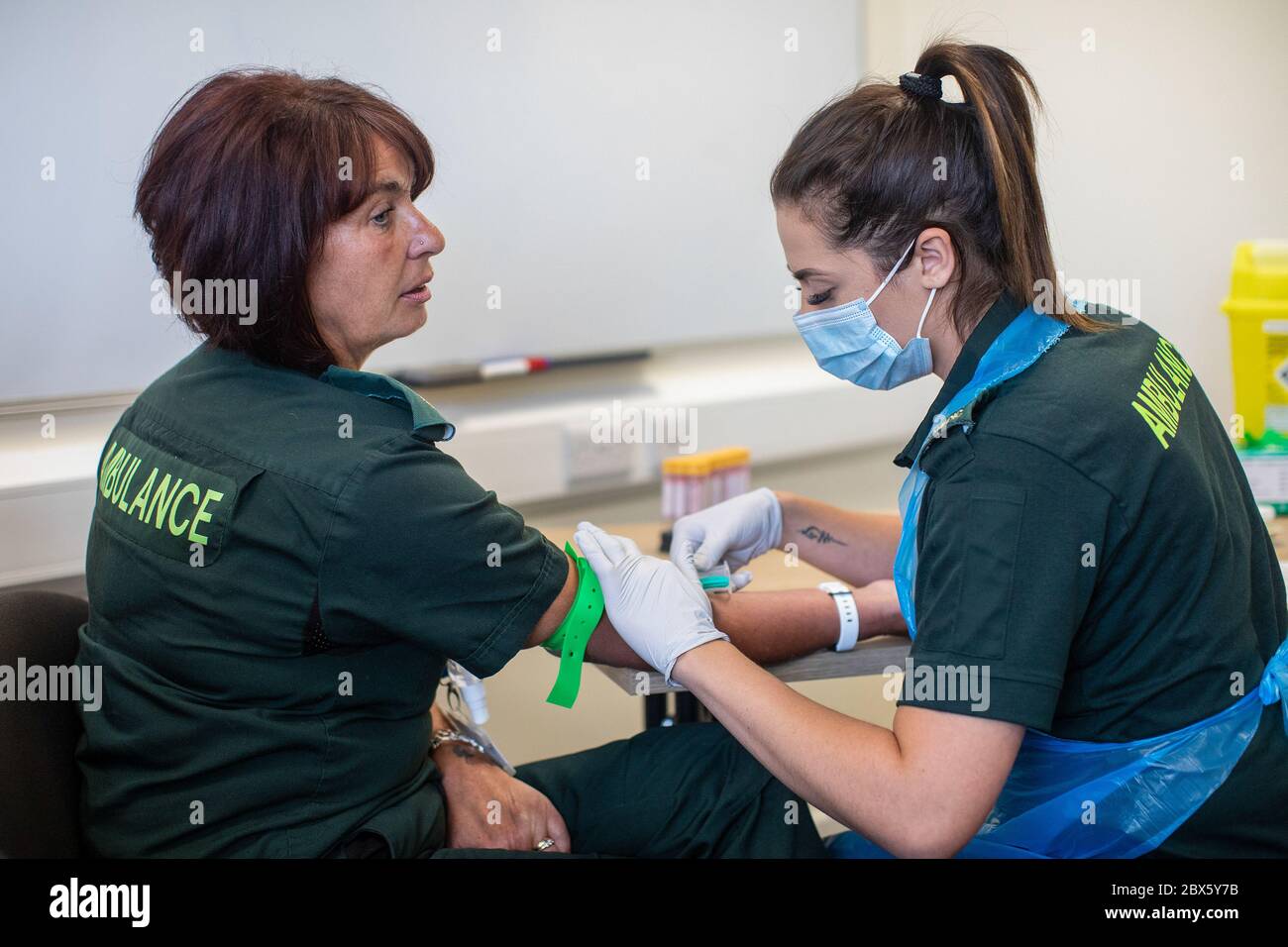 Paramedic Jess Baddams (right) takes a blood sample from Tracey Brooks ...