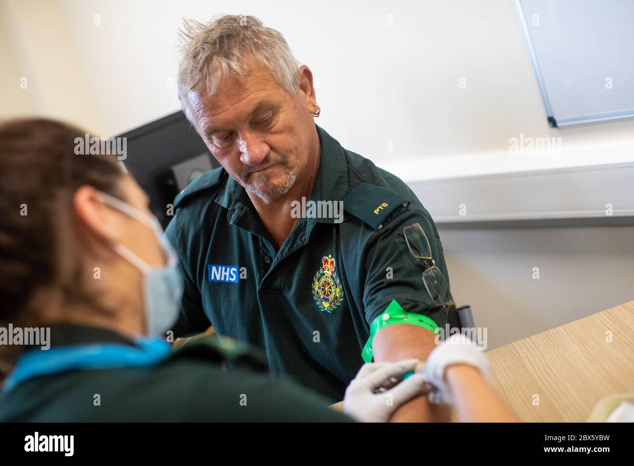 Paramedic Jess Baddams (left) takes a blood sample from Tony Oliver, a ...