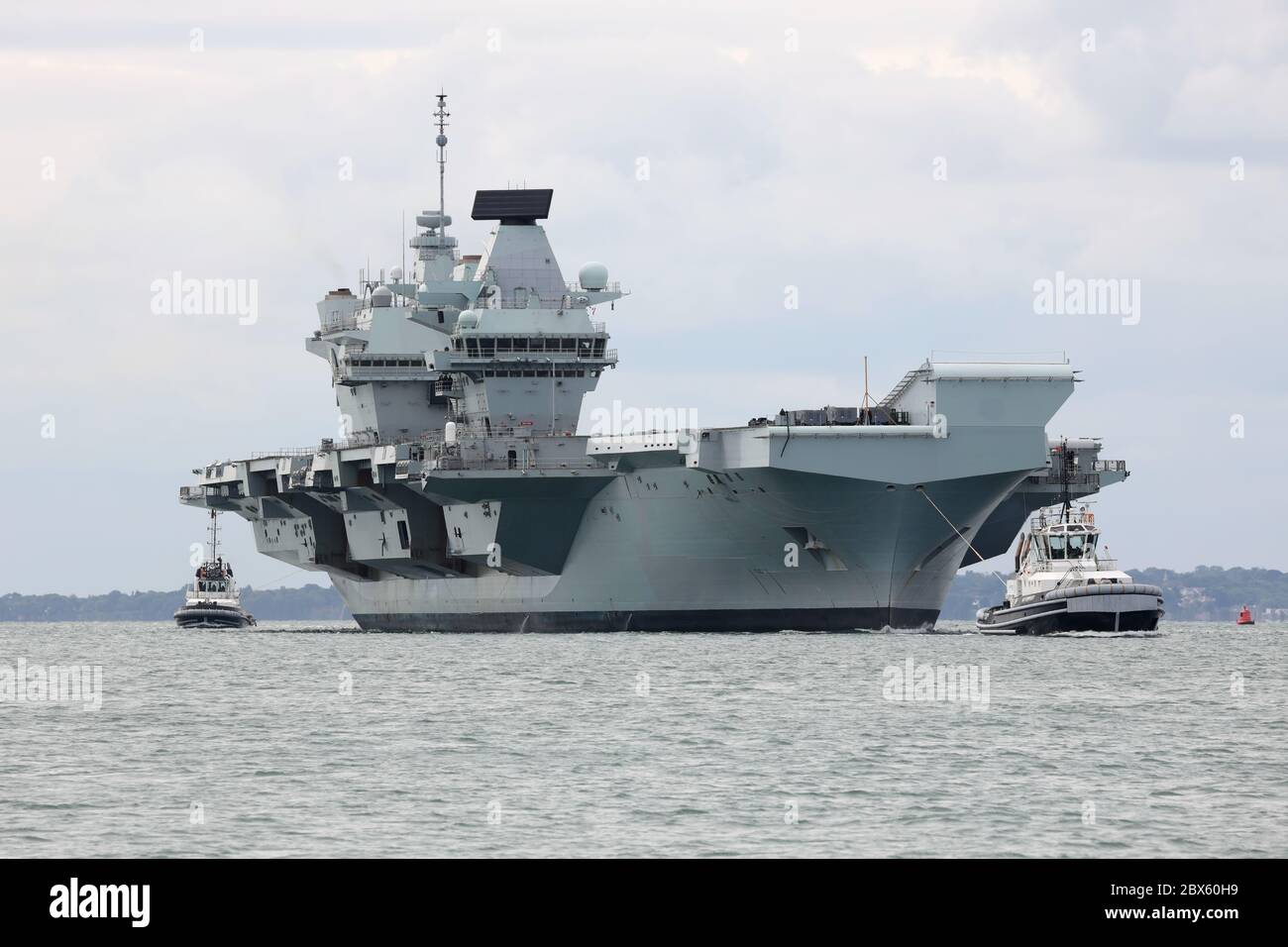 The aircraft carrier HMS QUEEN ELIZABETH returns to its base port to ...
