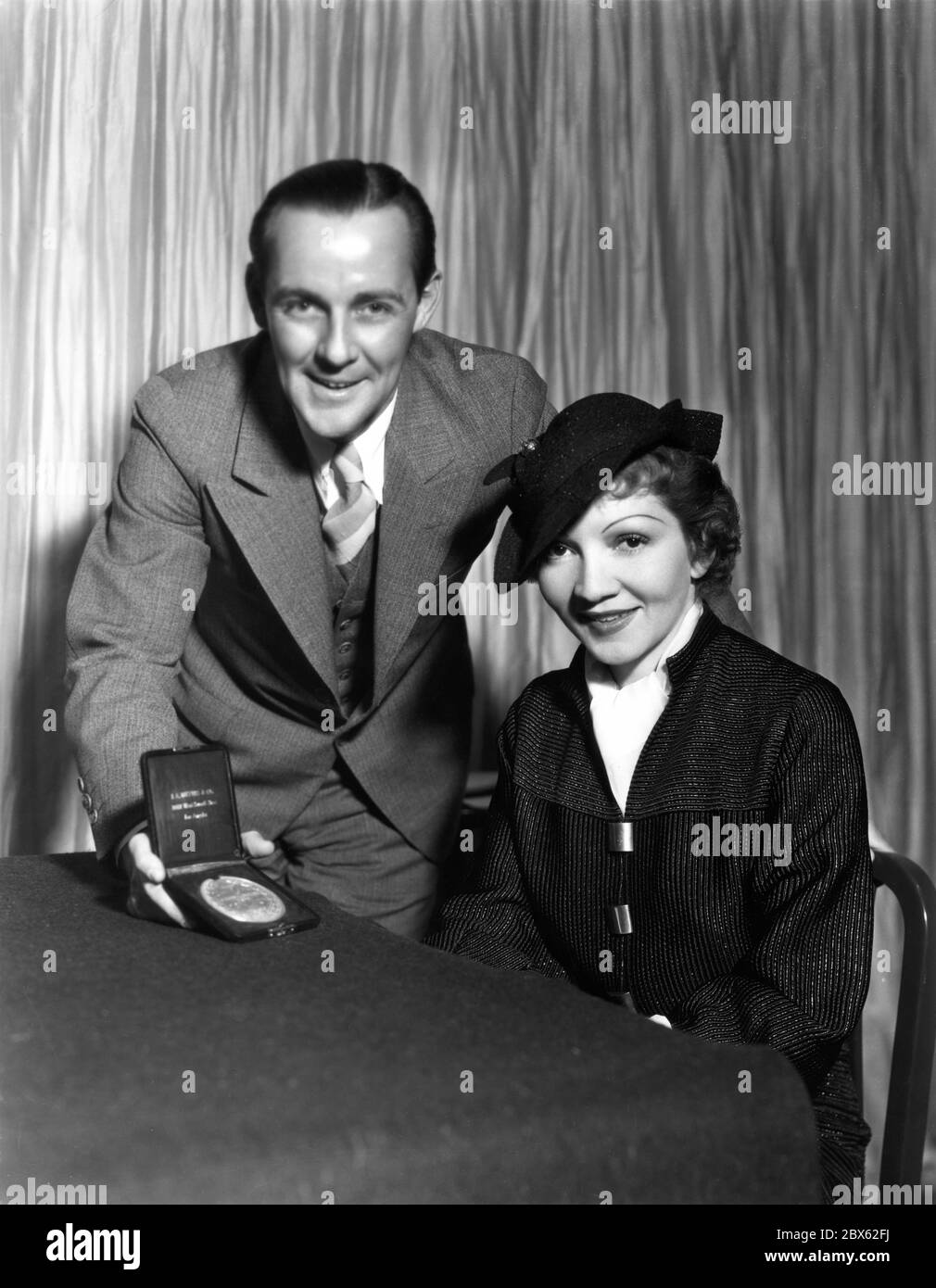 Hollywood Columnist JIMMIE FIDLER presents CLAUDETTE COLBERT with ...