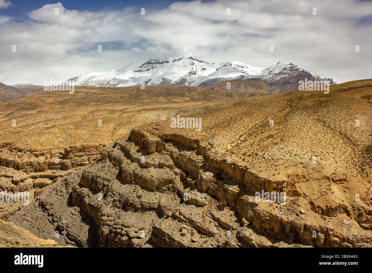 Dramatic landscape with steep walls of rocky canyons below a HImalayan ...