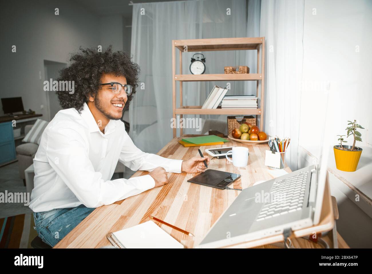 Creative young man hard working laptop at home in late evening. Smart ...