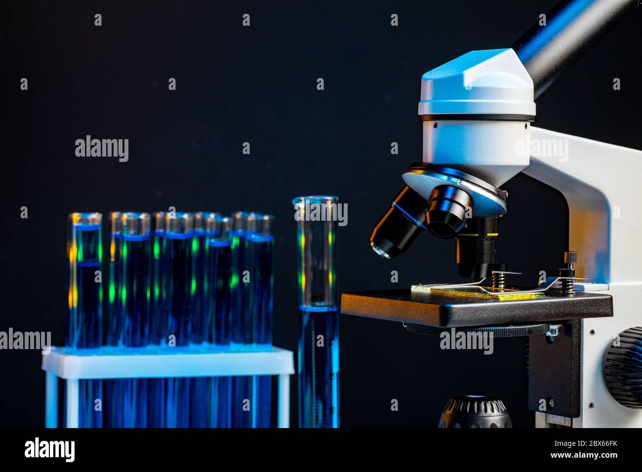 Microscope with lenses close up against dark background Stock Photo - Alamy