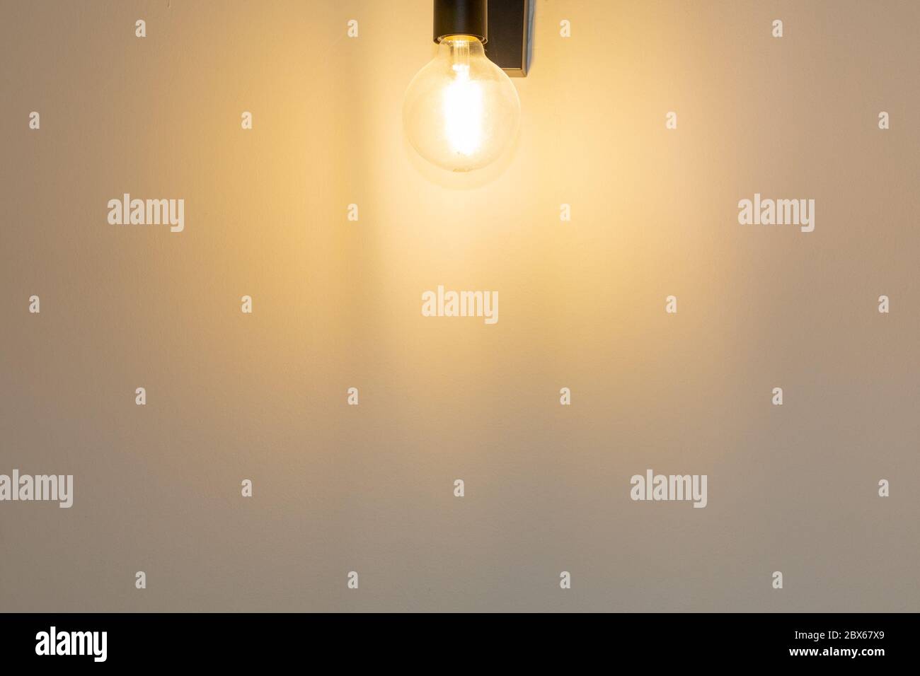 wall background with hanging bright lamp Stock Photo - Alamy