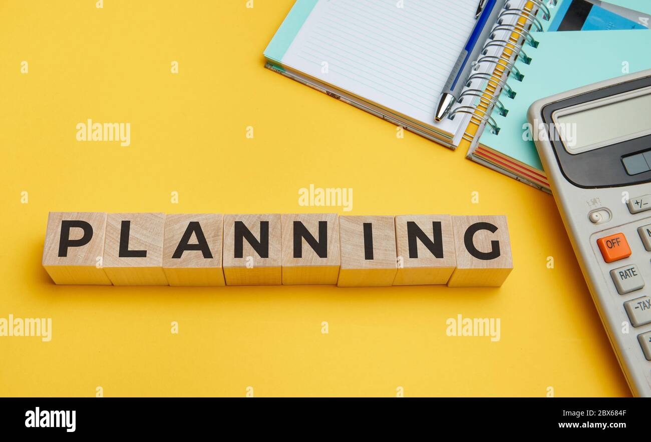 PLANNING word from wooden blocks on a yellow background Stock Photo - Alamy