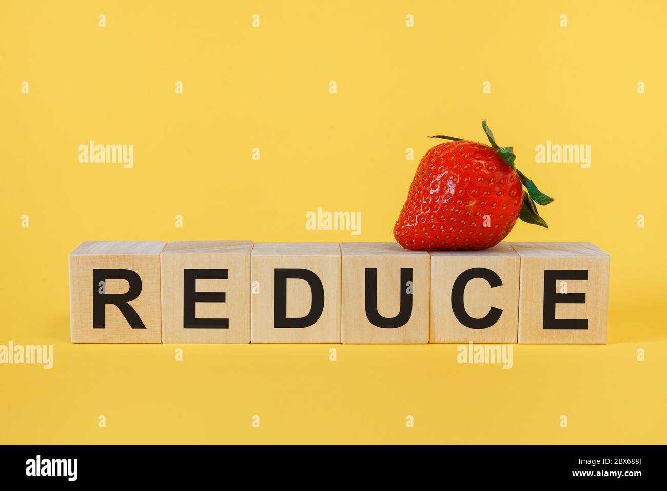 REDUCE Word Written on Wooden Cube. Concept Stock Photo - Alamy